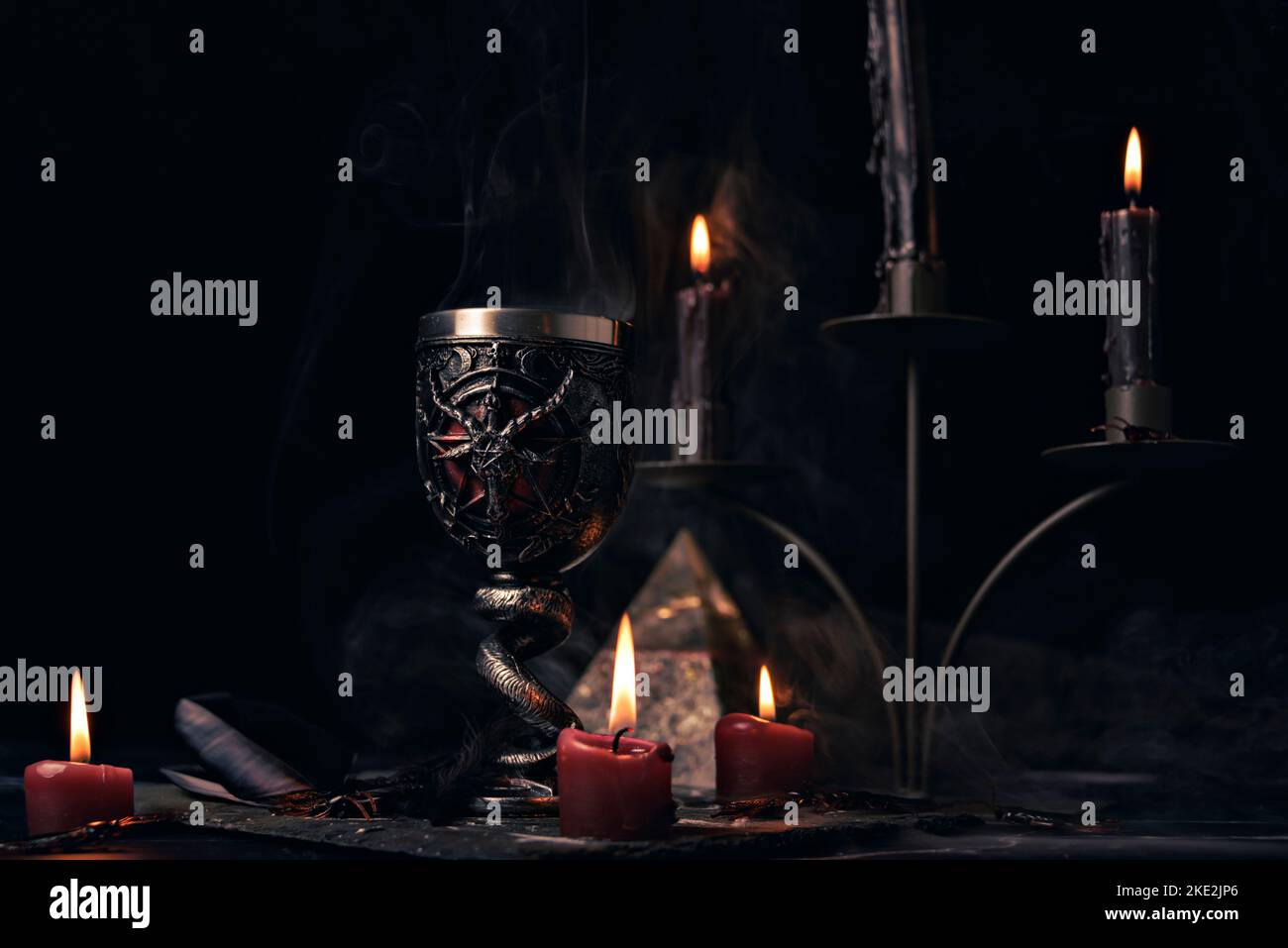 Witchcraft composition with candles, magic book and pentagram symbol ...