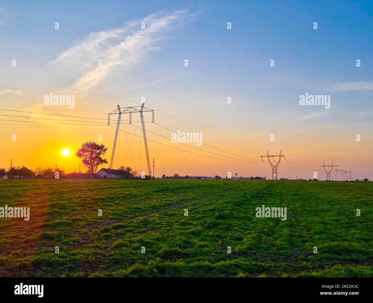 High voltage electric poles, rural landscape with power pylons in a row ...