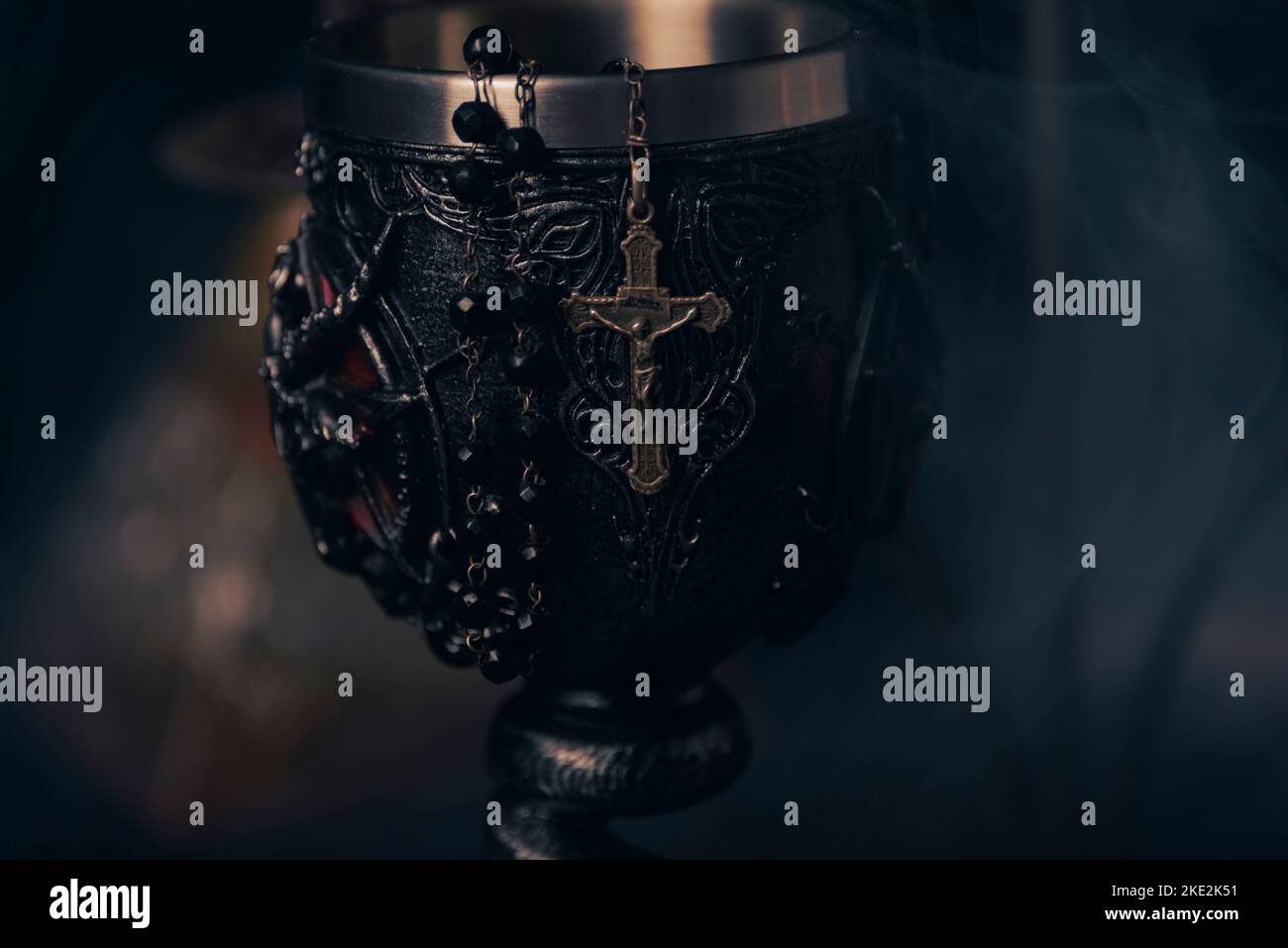 Witchcraft composition with burning candles, books, jewelry and ...