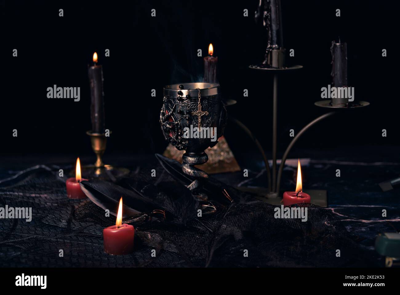 Witchcraft composition with candles, magic book and pentagram symbol ...