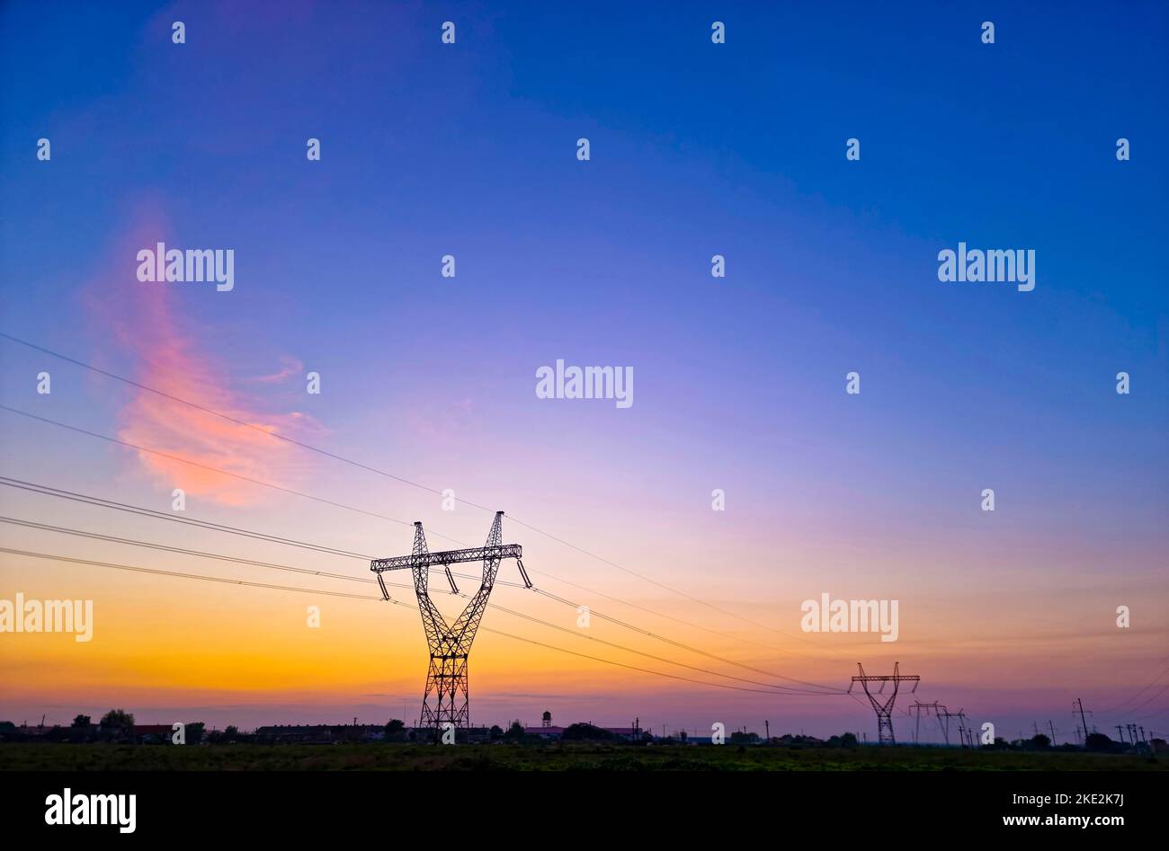 High voltage electric poles, rural landscape with power pylons in a row ...