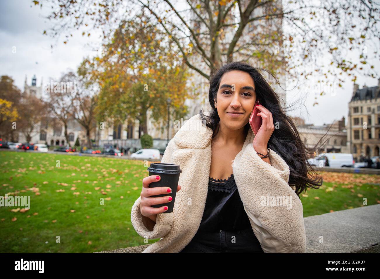Shyly smiling indian girl receiving calls during her break at the ...