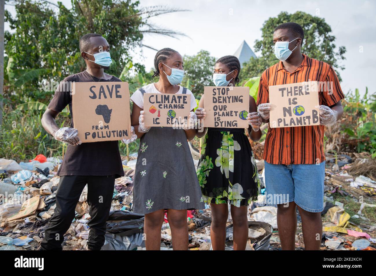 African youth protesting against pollution holding signs written:there ...