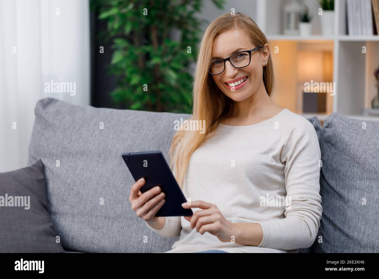 Smiling woman using tablet Stock Photo - Alamy