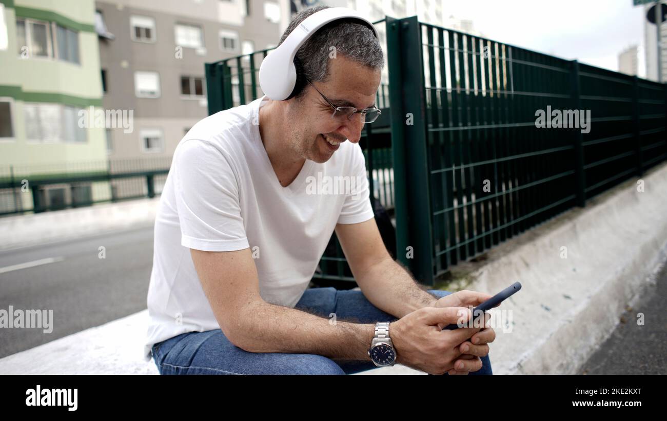 man listening to music and smiling Stock Photo - Alamy