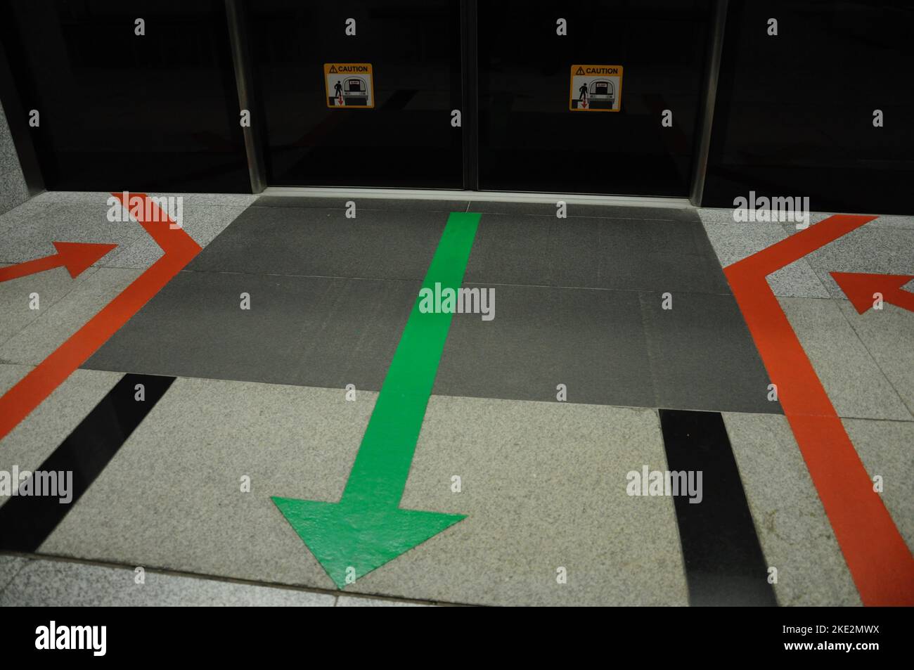 Subway train station platform with passenger control marking and arrows ...