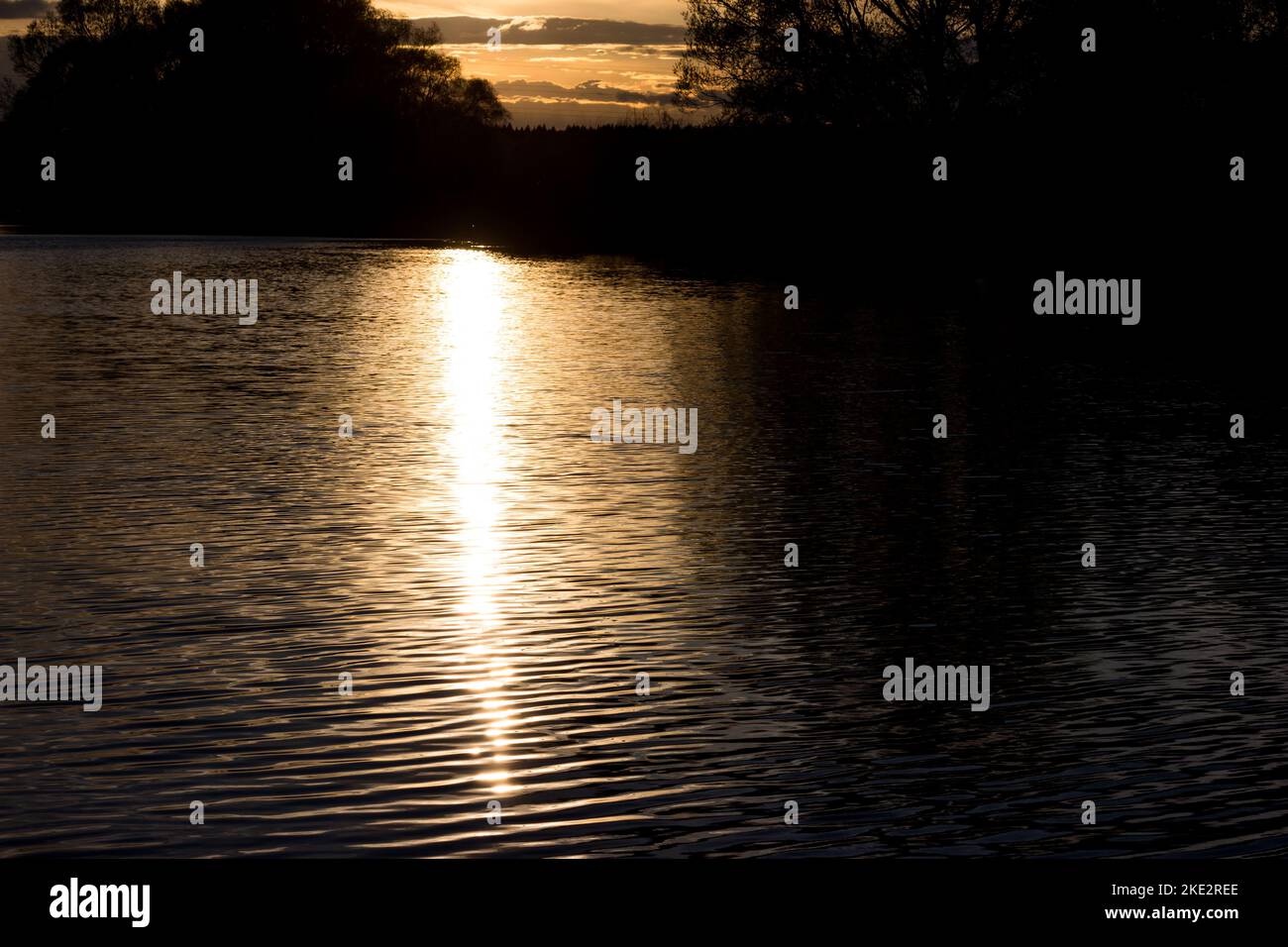 Reflection of the sun on the water during sunset background Stock Photo ...