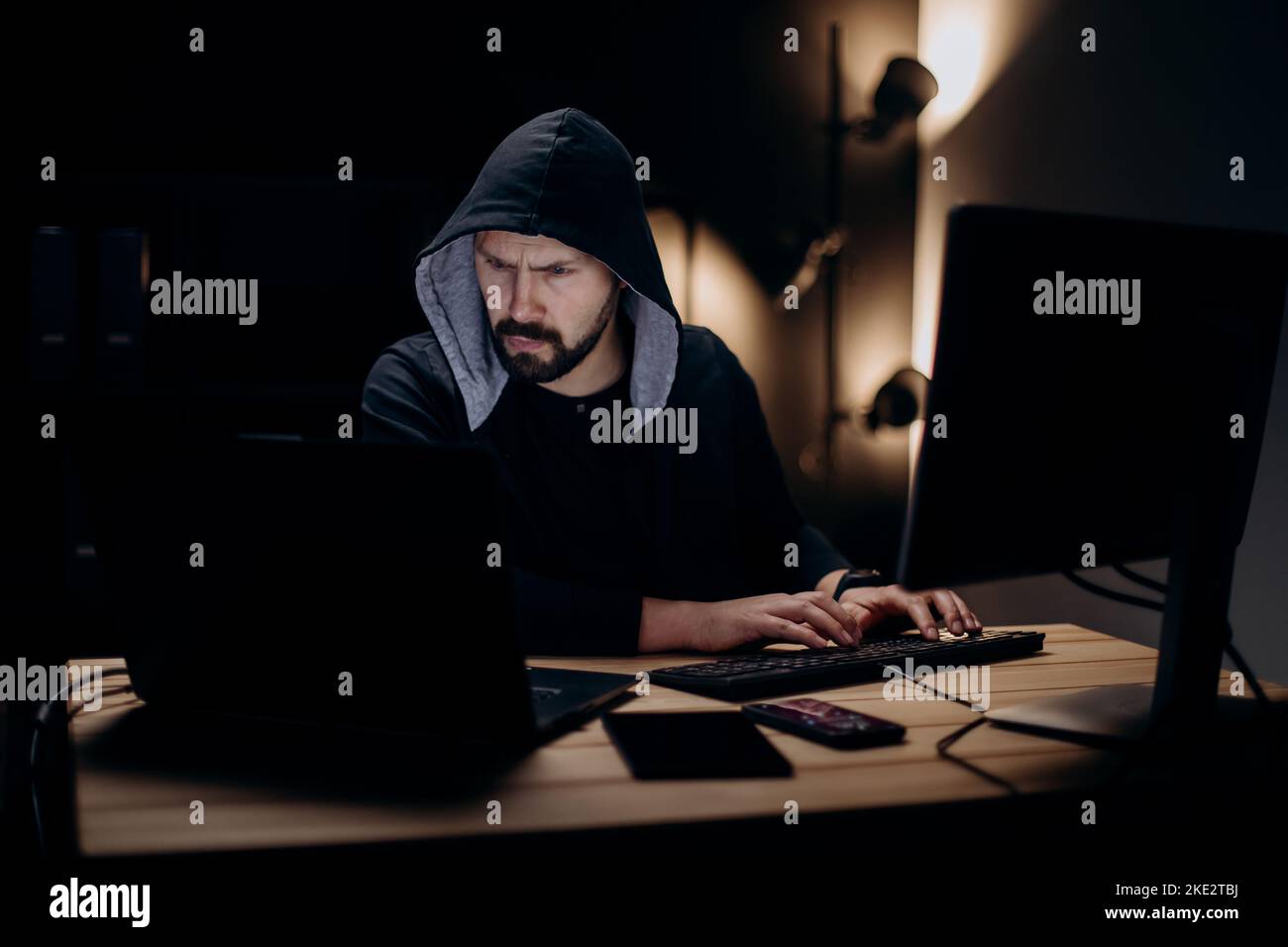 Hacker with computers Stock Photo - Alamy
