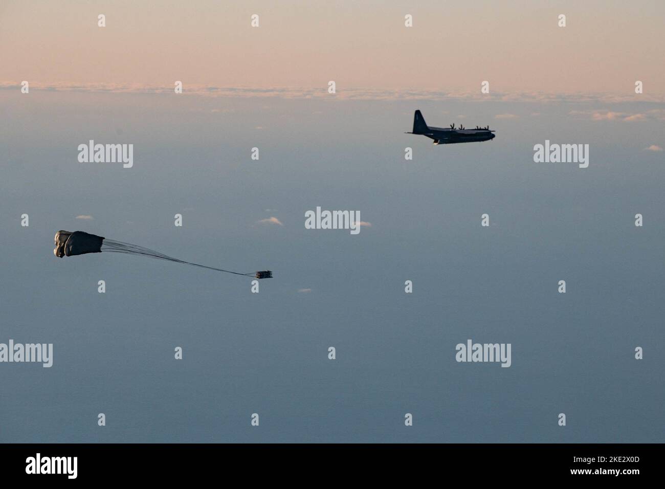 A palletized munitions system falls from the cargo hold of a 352d ...