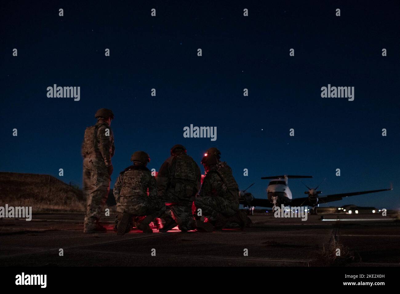 Members of the 137th Mission Sustainment Team look over a map as they ...