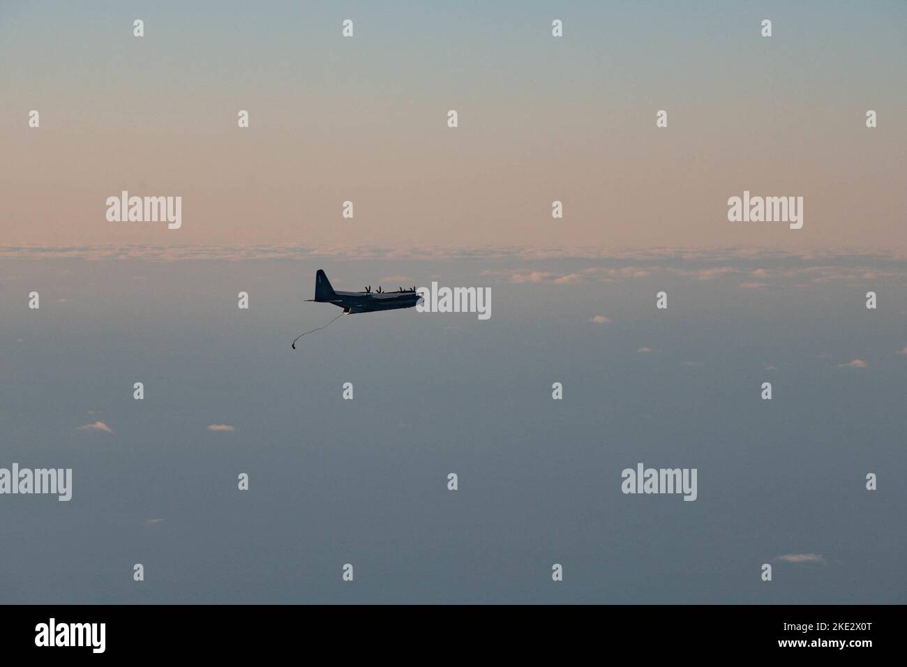 A palletized munitions system falls from the cargo hold of a 352d ...