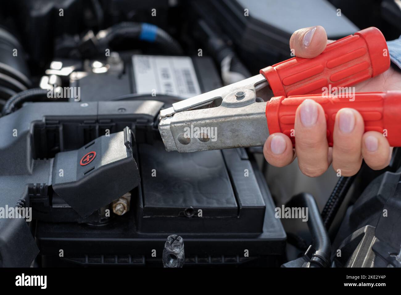Emergency stop of the car. Woman hand holds the wire Crocodile clip ...
