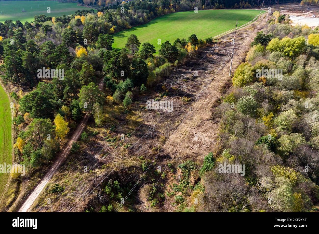 Aerial view of a clearing of power lines in a forest area landscape ...