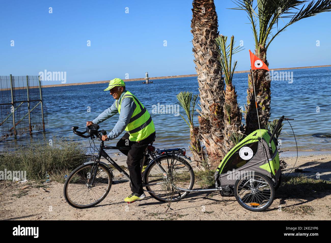 An environmental activist Ali Ruqaibi seen riding a bike and pulling a ...