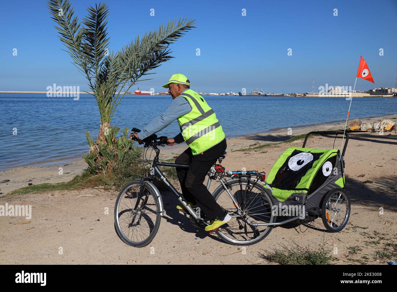 An environmental activist Ali Ruqaibi seen riding a bike and pulling a ...