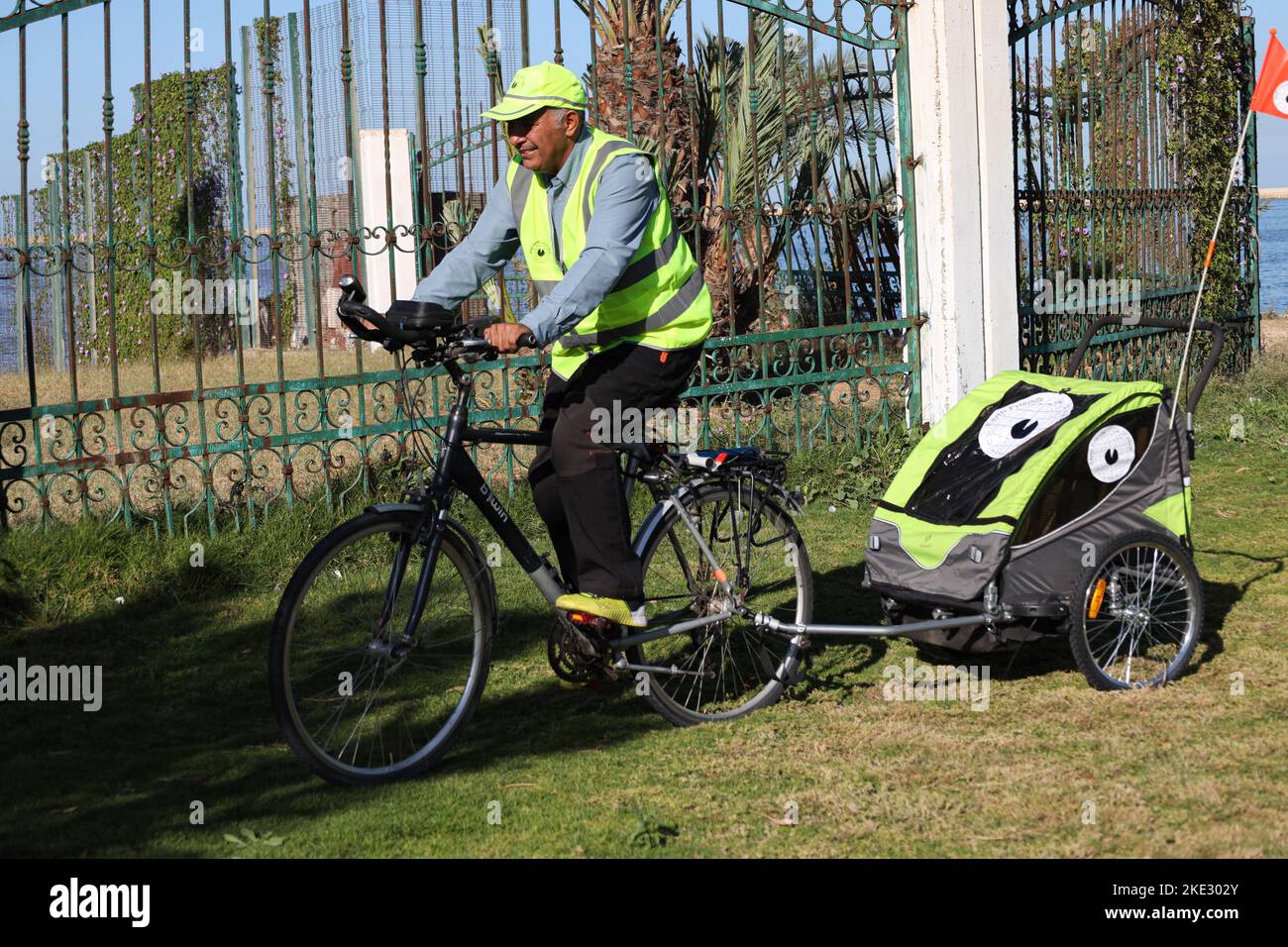 An environmental activist Ali Ruqaibi seen riding a bike and pulling a ...