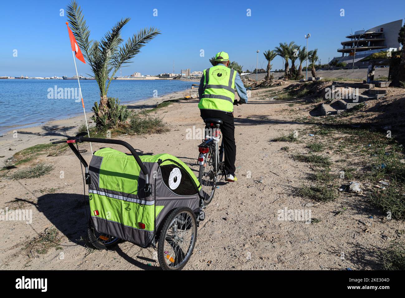 An environmental activist Ali Ruqaibi seen riding a bike and pulling a mobile cart carrying ...
