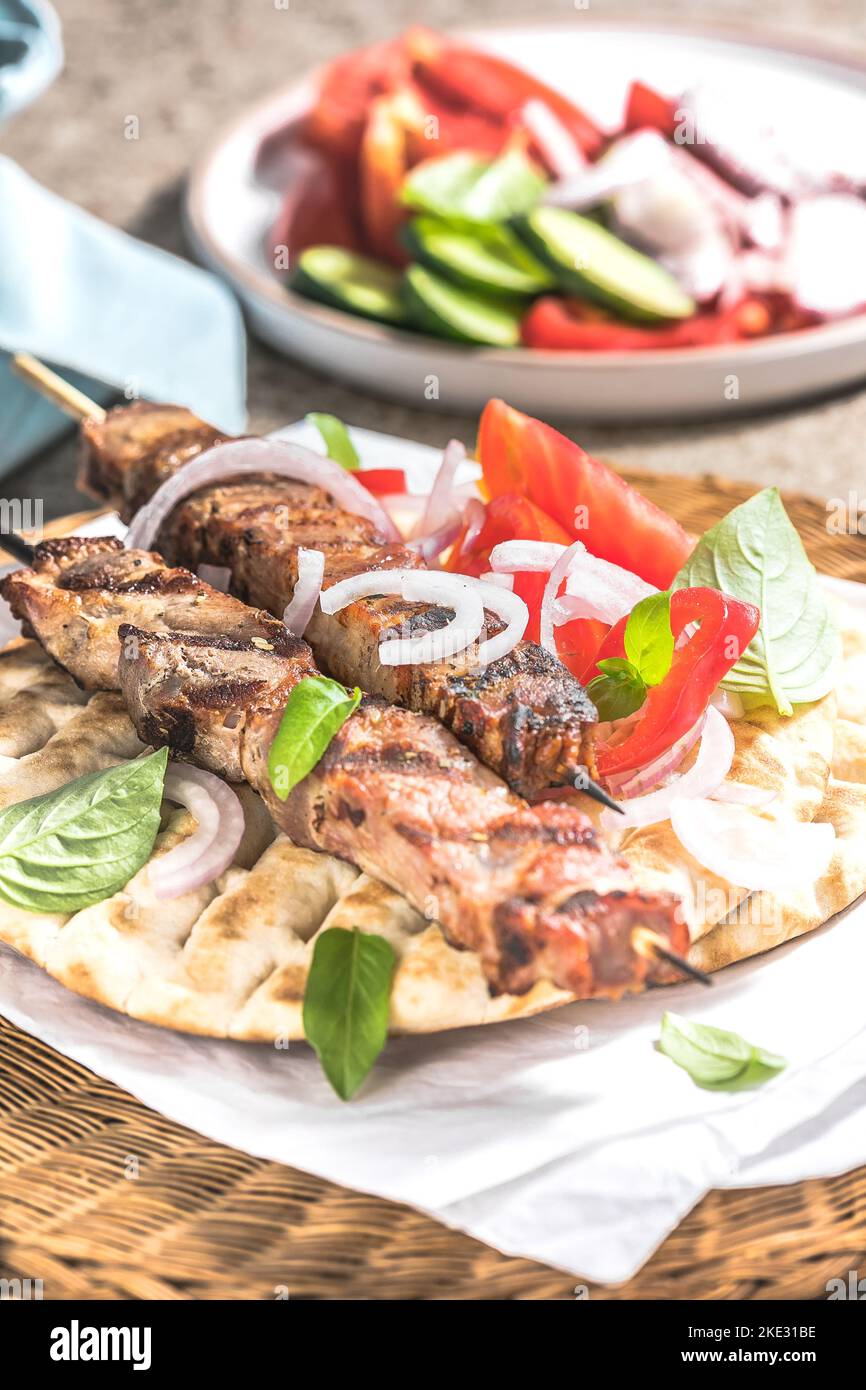 Pork souvlaki, kebabs on skewers with salad and fresh home made ...