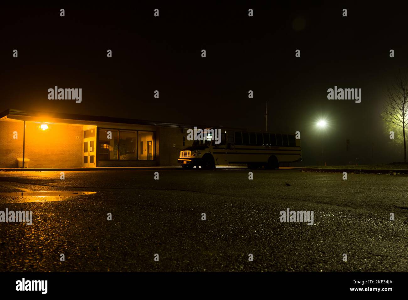 A school bus near the school on a mystical Halloween night. Night ...