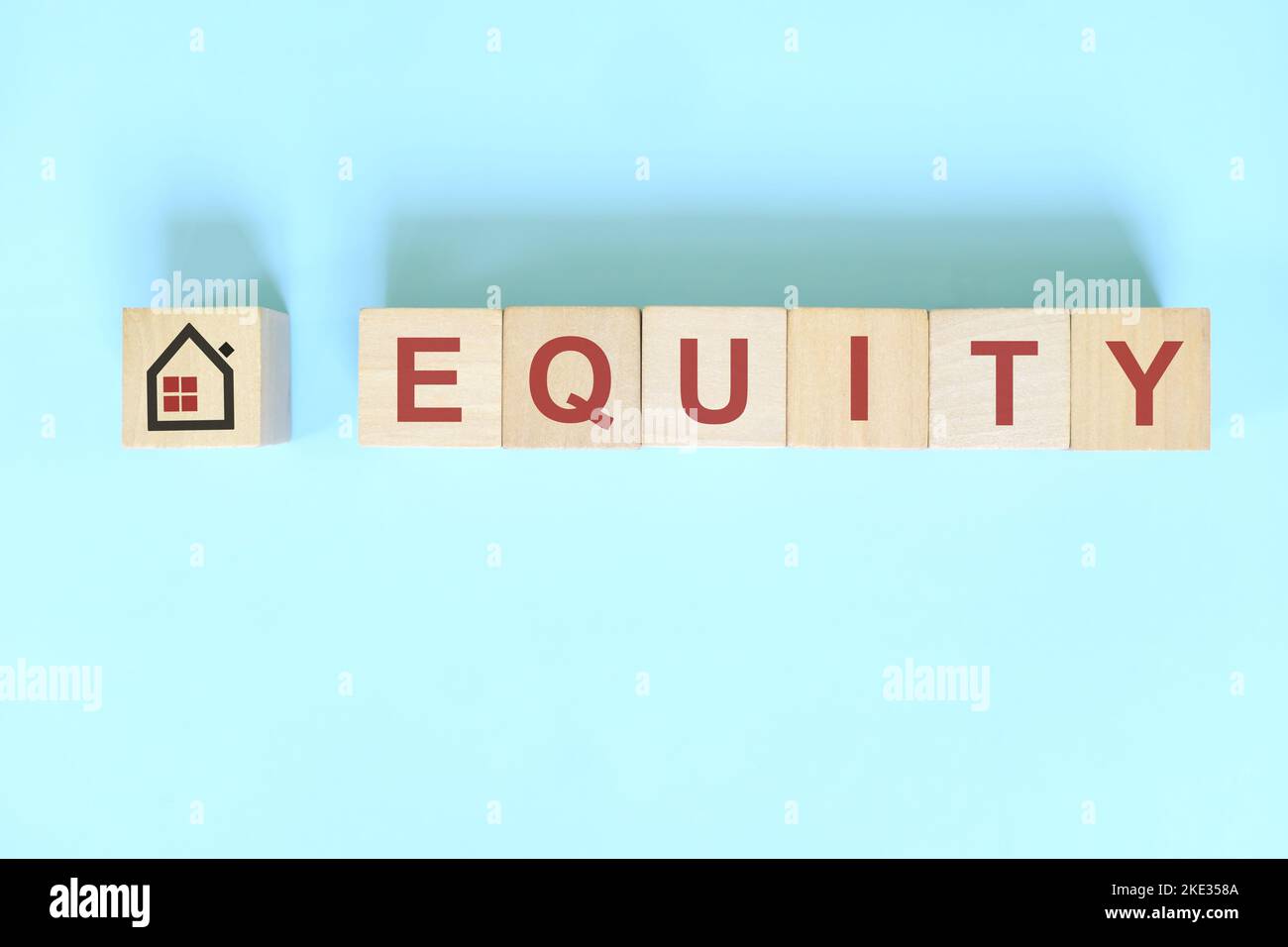 Equity concept in real estate. Wooden blocks typography on blue ...