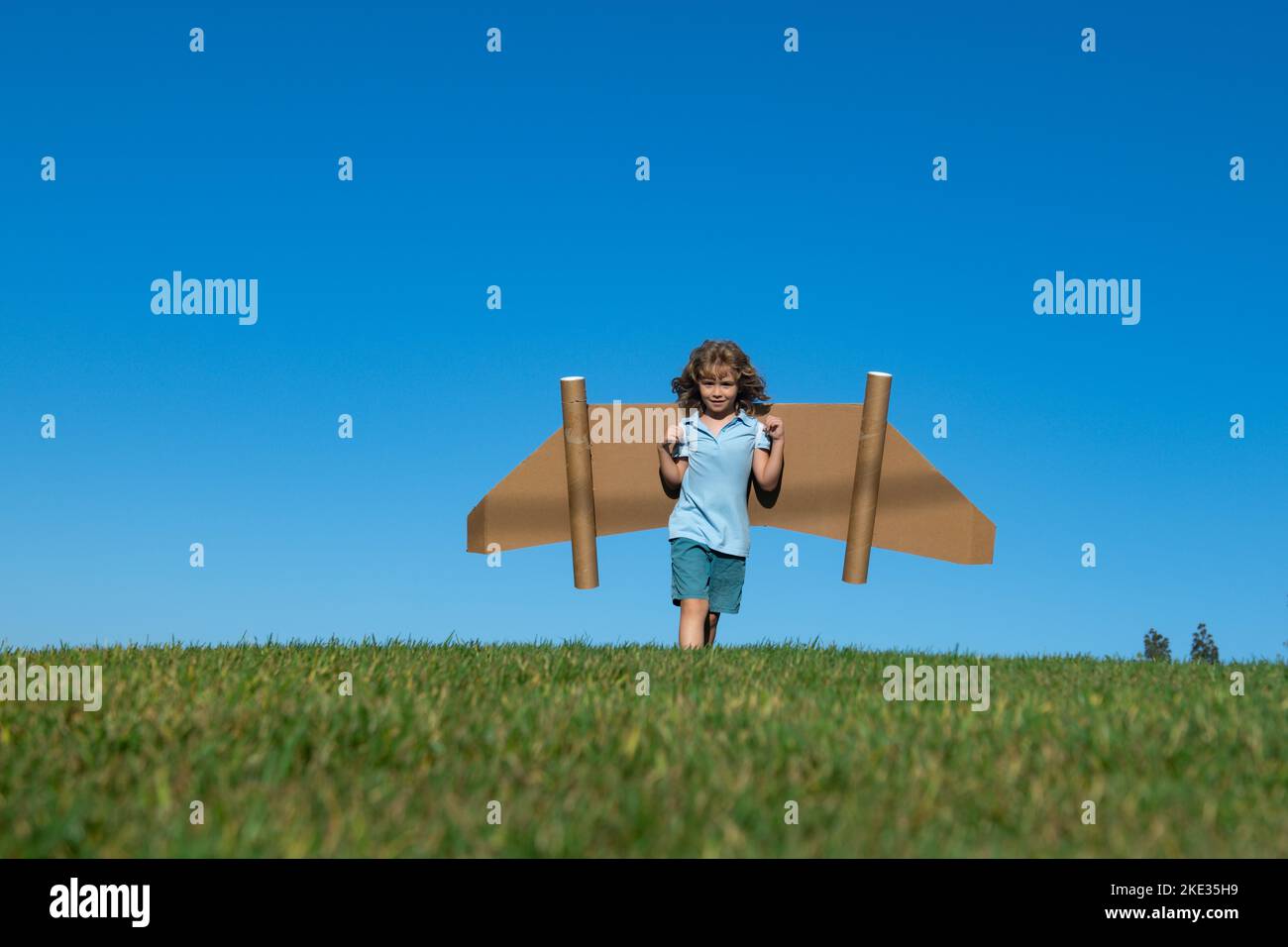 Happy child playing with toy jetpack. Kid pilot having fun outdoor ...