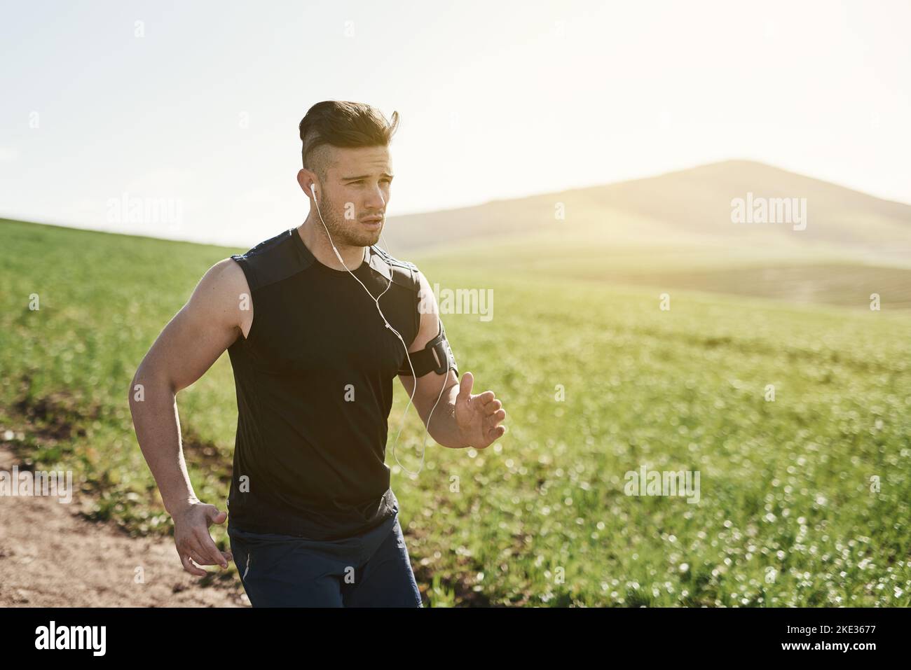 Dedicated to his workout. a handsome young man running outdoors Stock ...