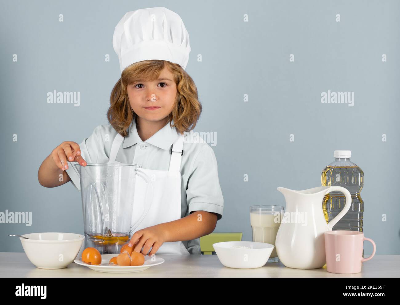 Cooking children. Chef kid boy making fresh vegetables for healthy eat ...