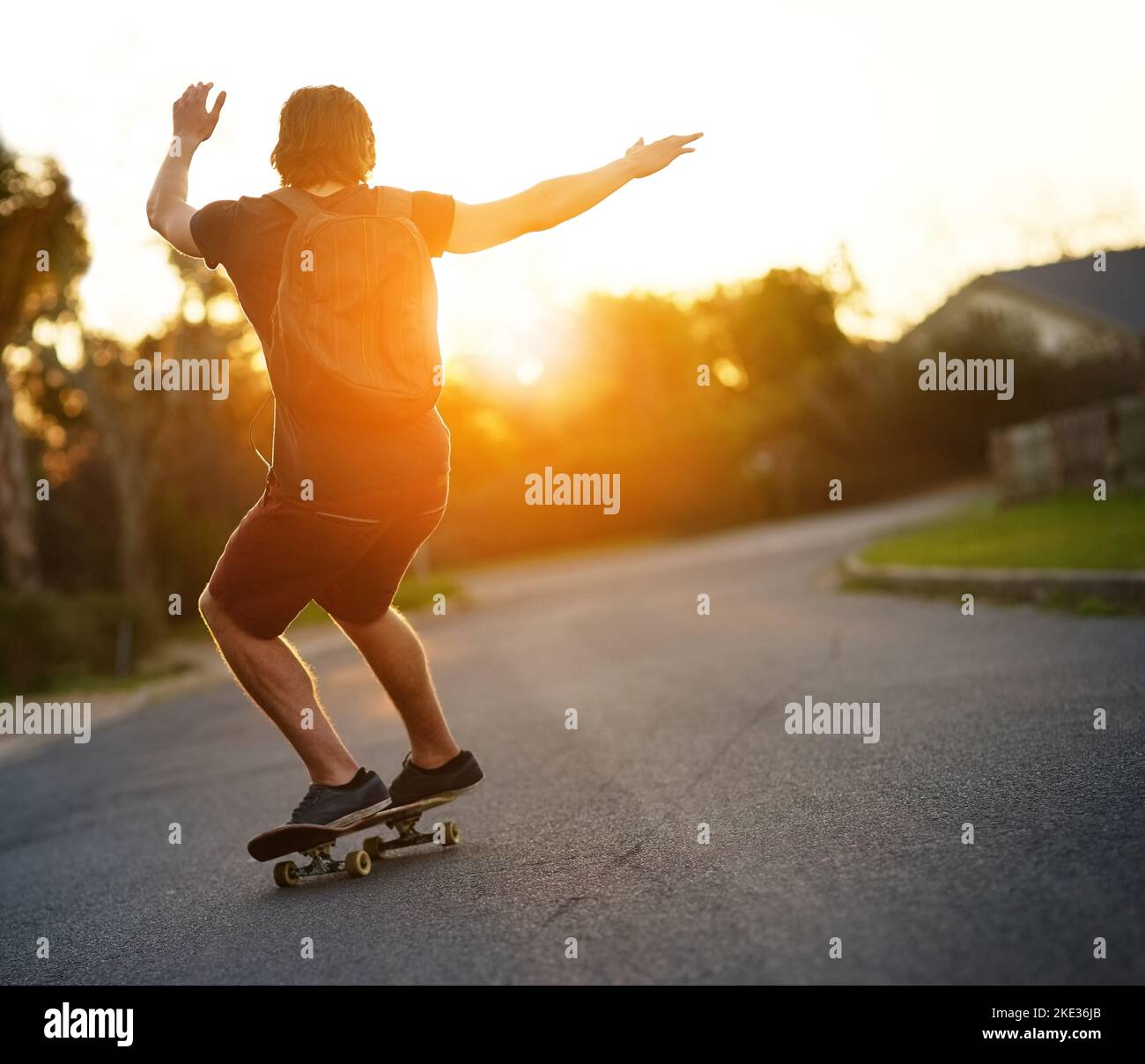 Rolling down the streets with some cool moves. Rear view shot of a ...