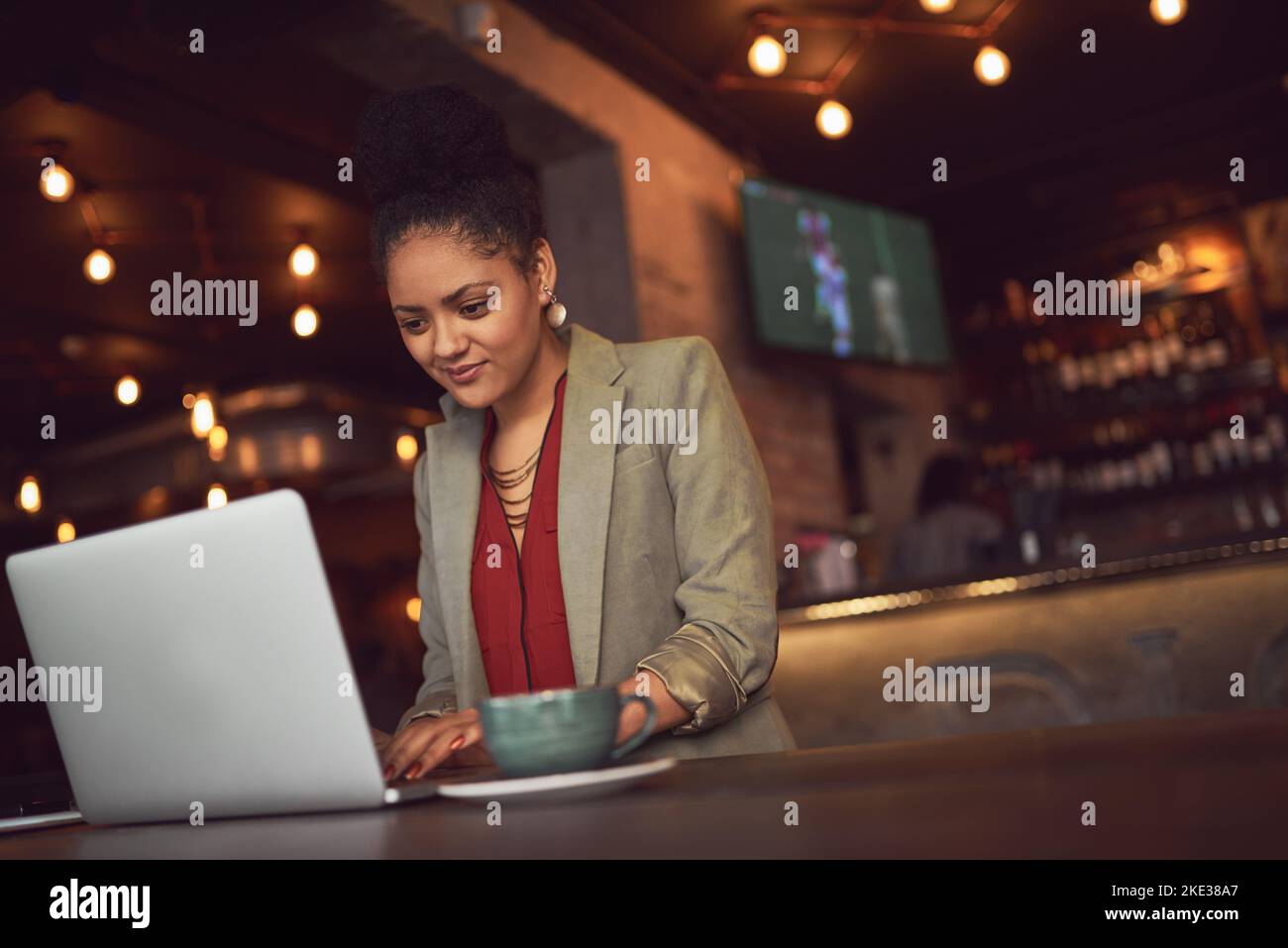 Catching up on her emails. a young businesswoman working on her laptop ...