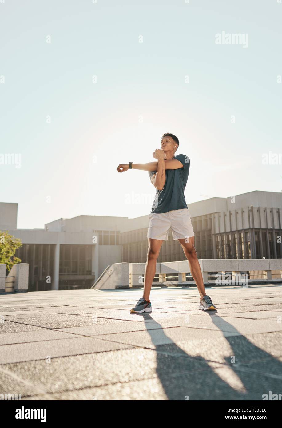City fitness, arm stretch and man exercise at sunrise, cardio and ...