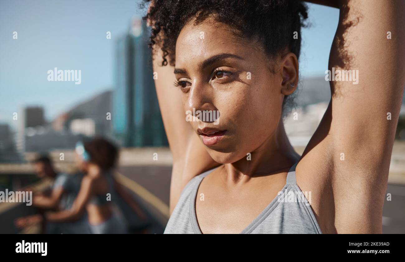 Fitness, woman and stretching arm, training and exercise for health and wellness in the city ...