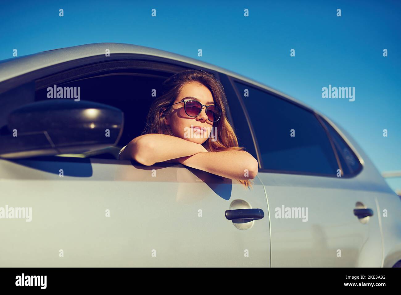 The views are incredible out here. a young woman looking at the view ...