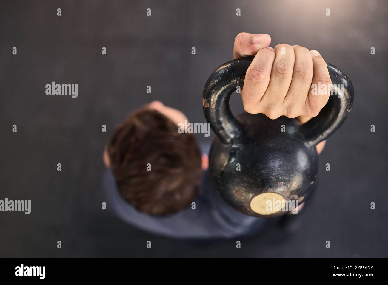 Fitness, bodybuilding and kettlebell workout by man at a gym from above ...