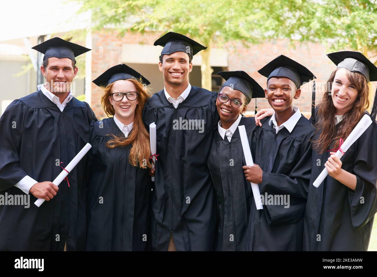 Officially qualified. Portrait of a happy group of students standing ...