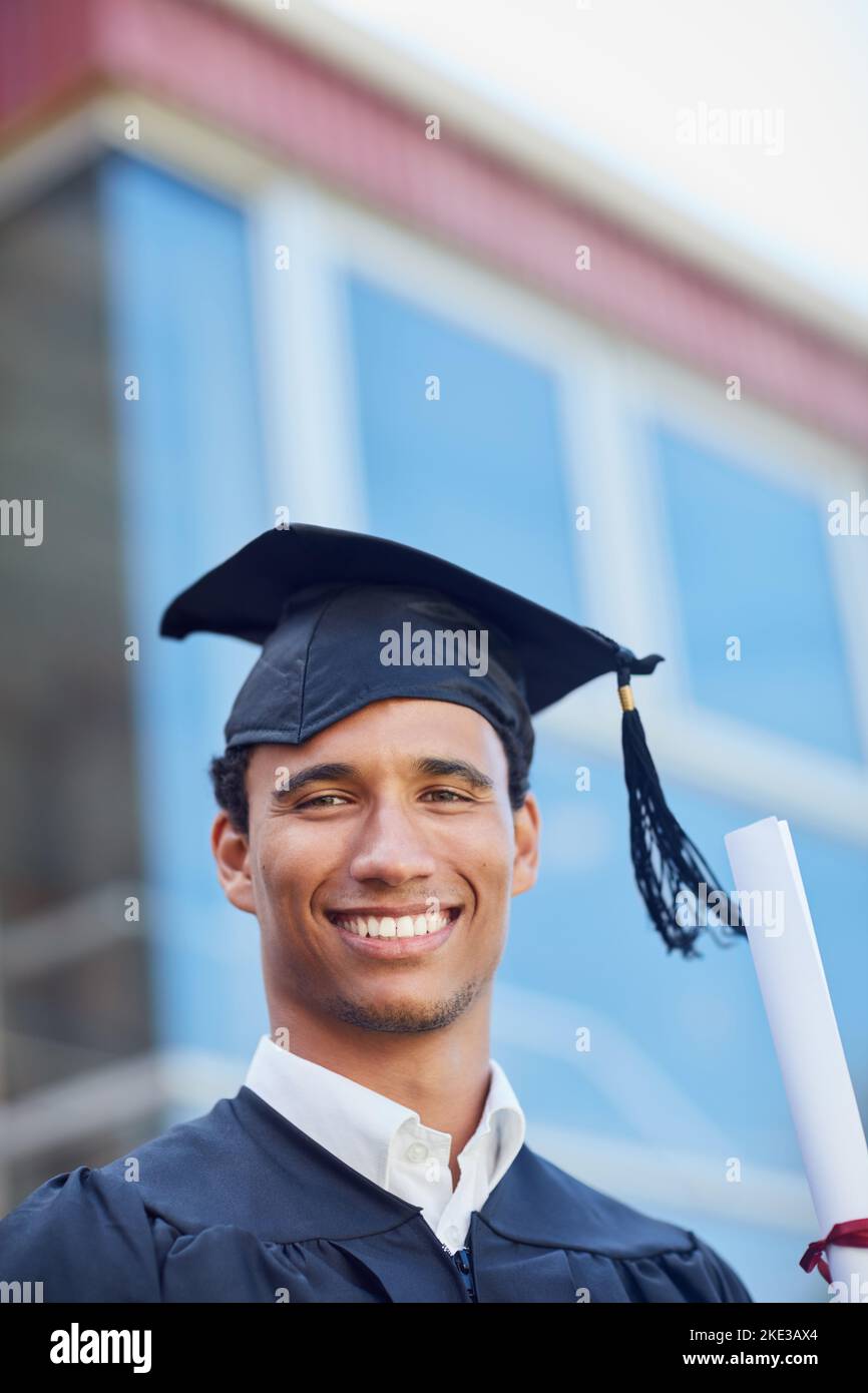 My parents are so proud. Portrait of a happy male student standing ... My parents are so proud. Portrait of a happy male student standing ...