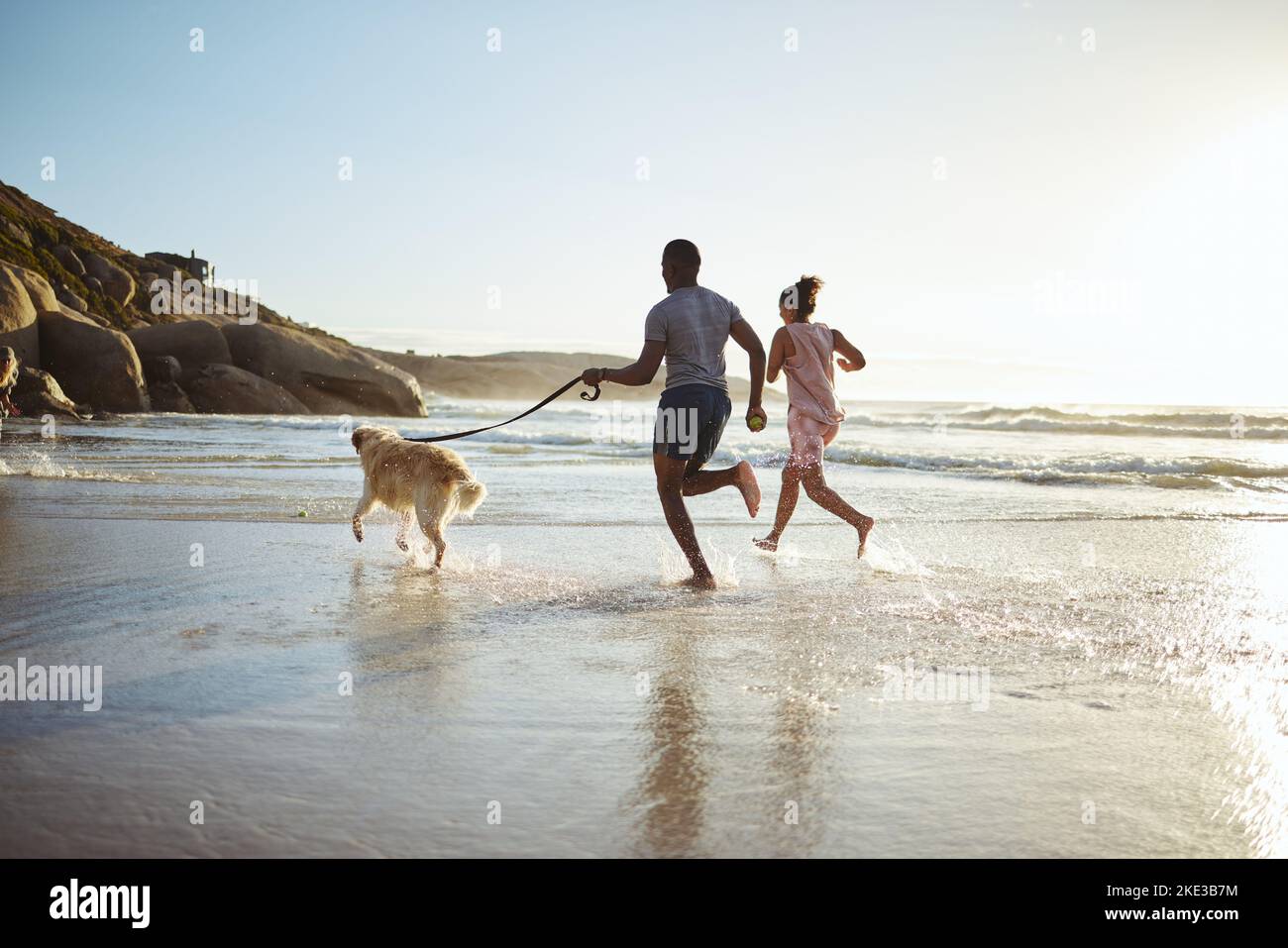 Exercise, couple and dog at the beach for running, training and fitness ...