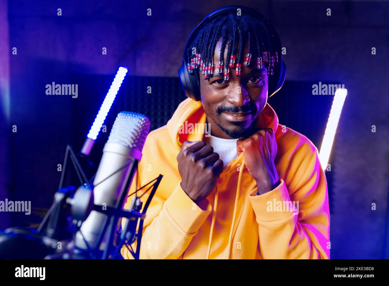 Young African performer recording his new track in recording studio ...