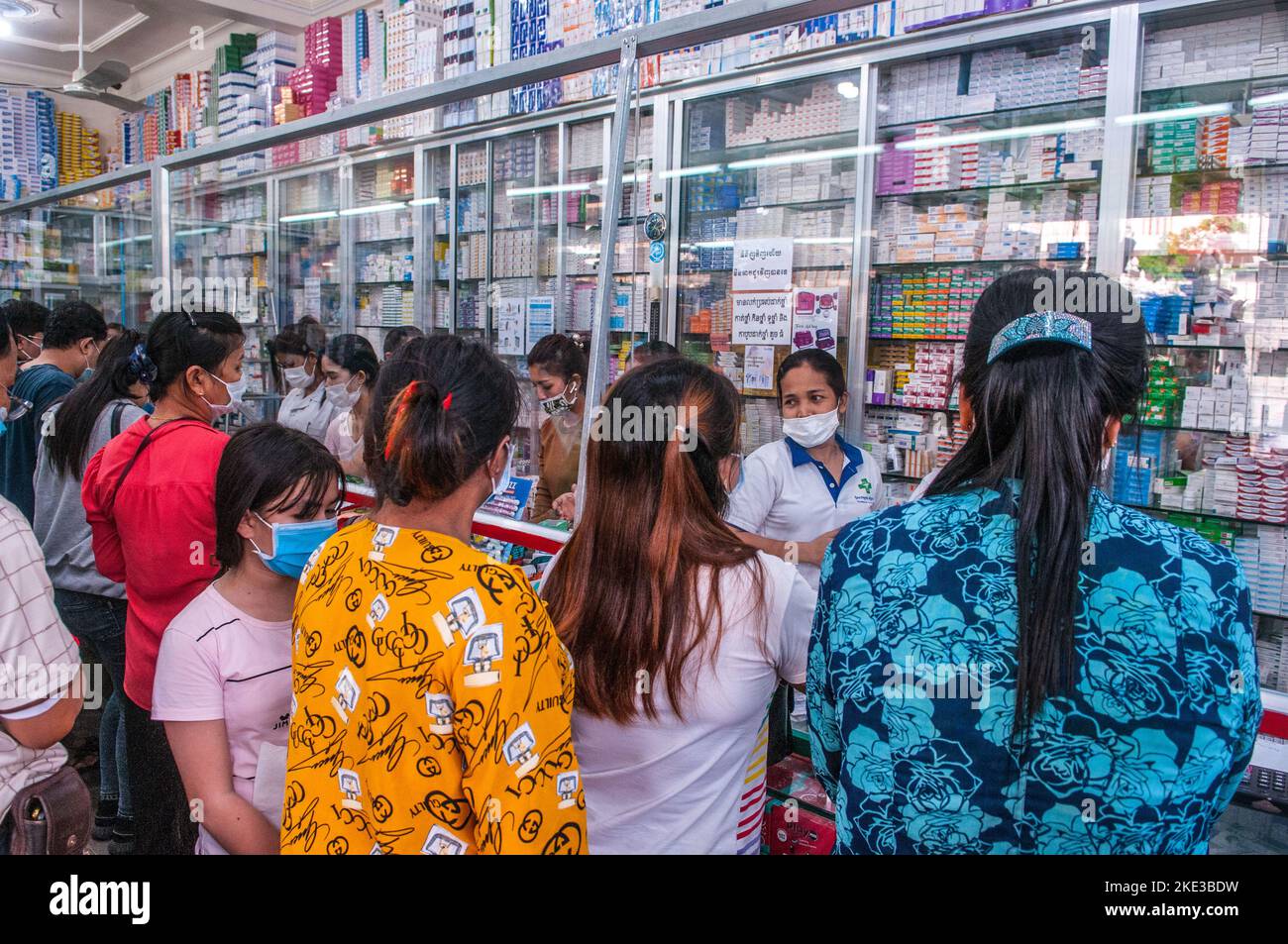 COVID panic buying, customers wearing protective face masks wait inside ...