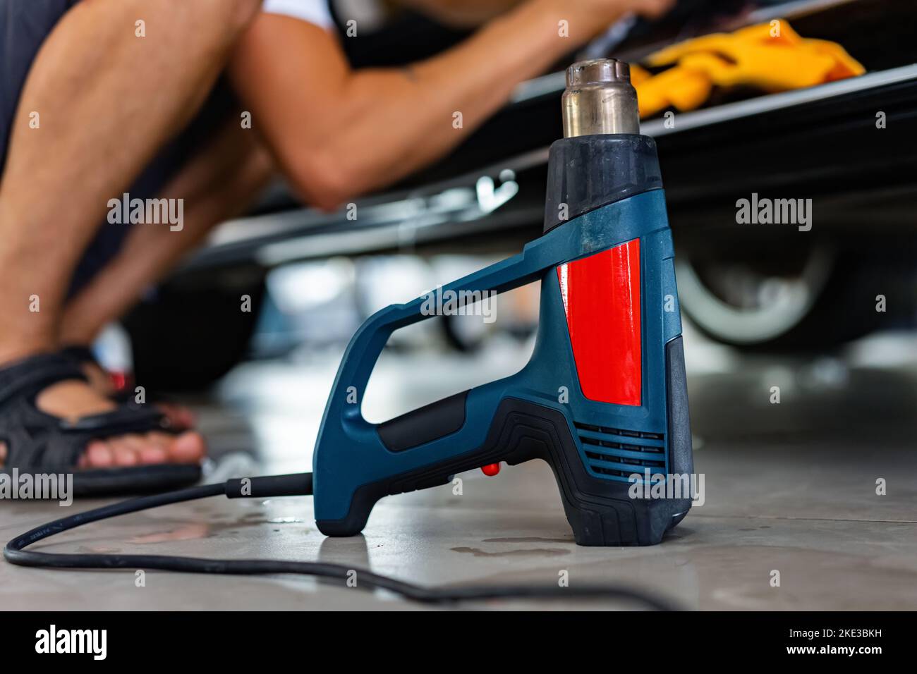 Worker applies car protection film on a car in detailing service Stock ...