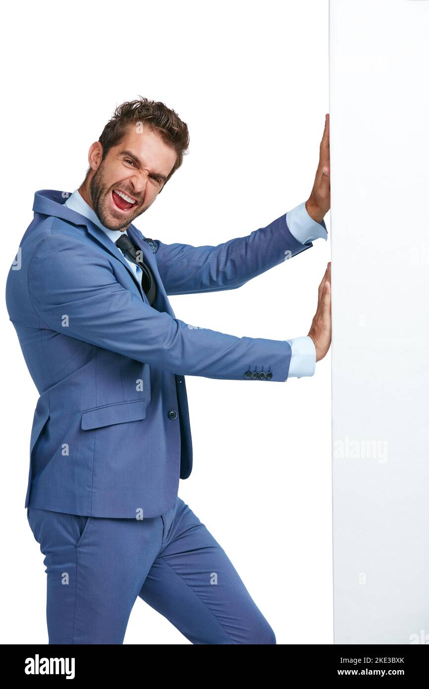 Challenge your limits. Studio shot of a handsome businessman pushing a ...
