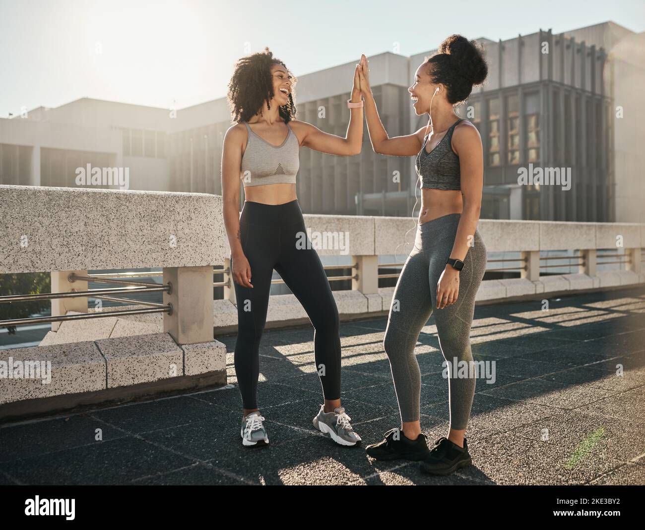 Fitness, friends and high five in the city for workout, exercise or ...