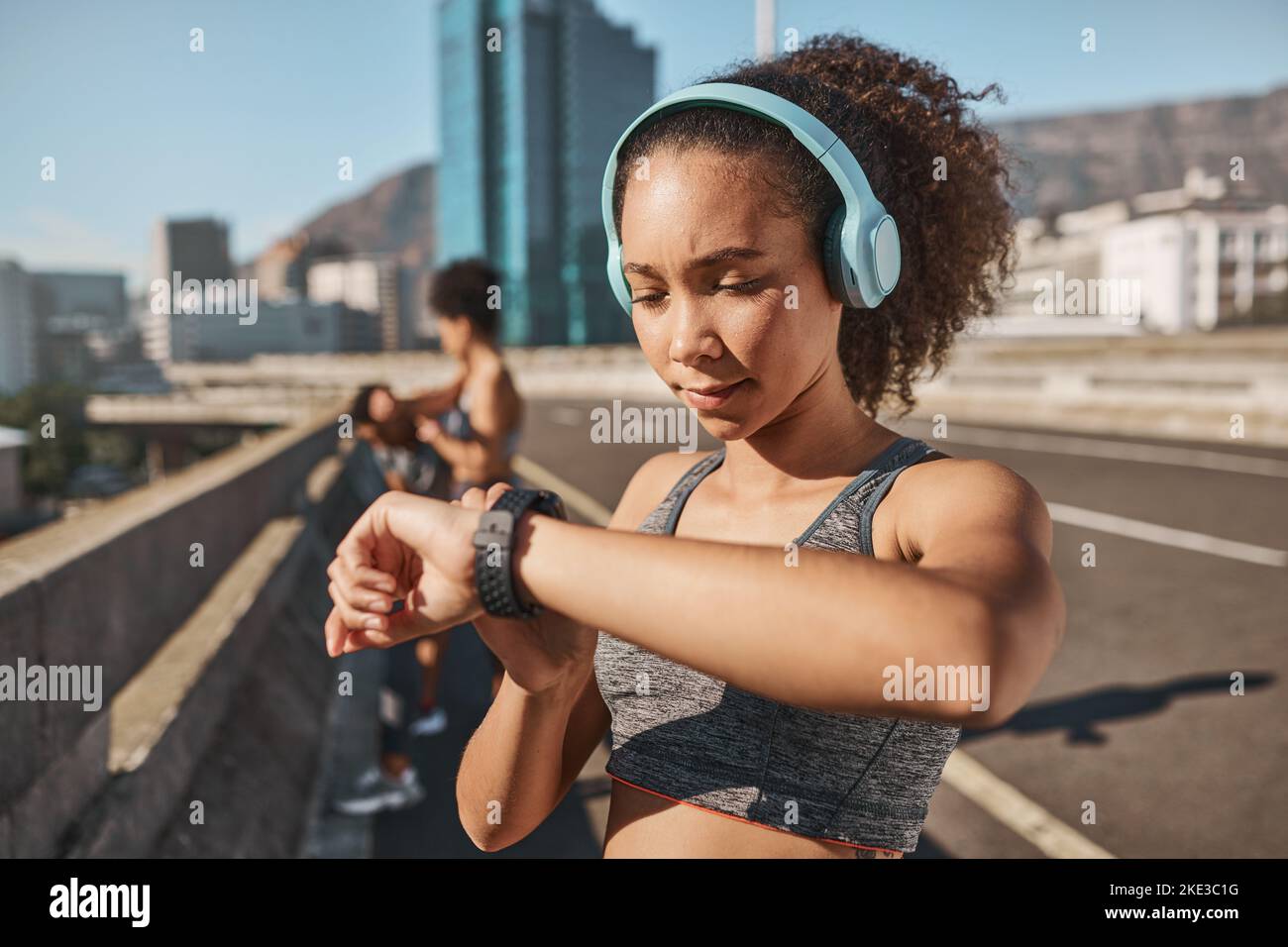 Smartwatch, headphones and fitness black woman in city with running ...