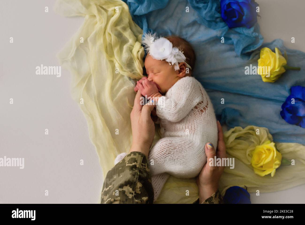 Ukrainian newborn in the studio patriotic blue yellow colors during the ...