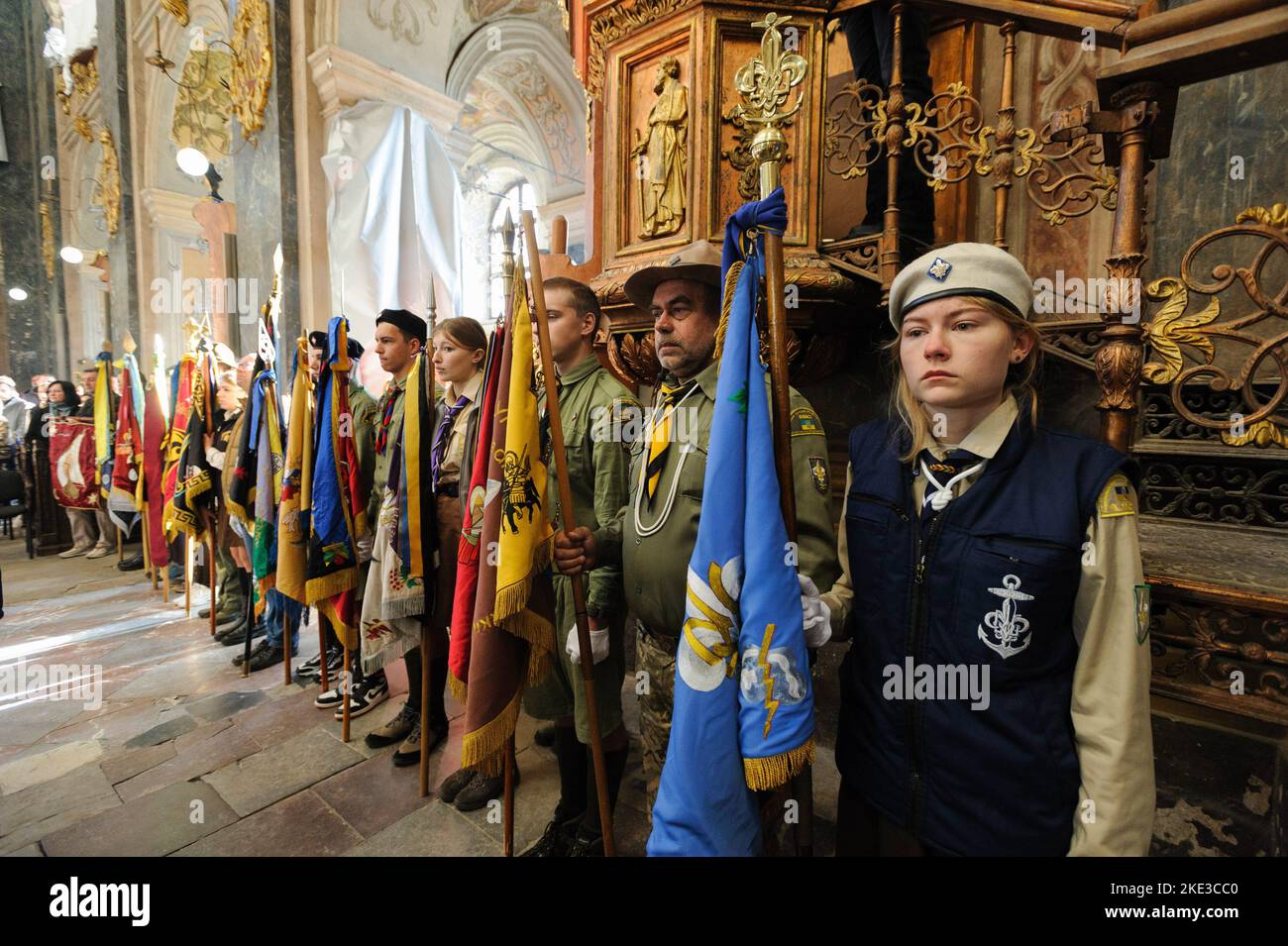 Members of the Ukrainian Plast scouting organization hold flags during ...