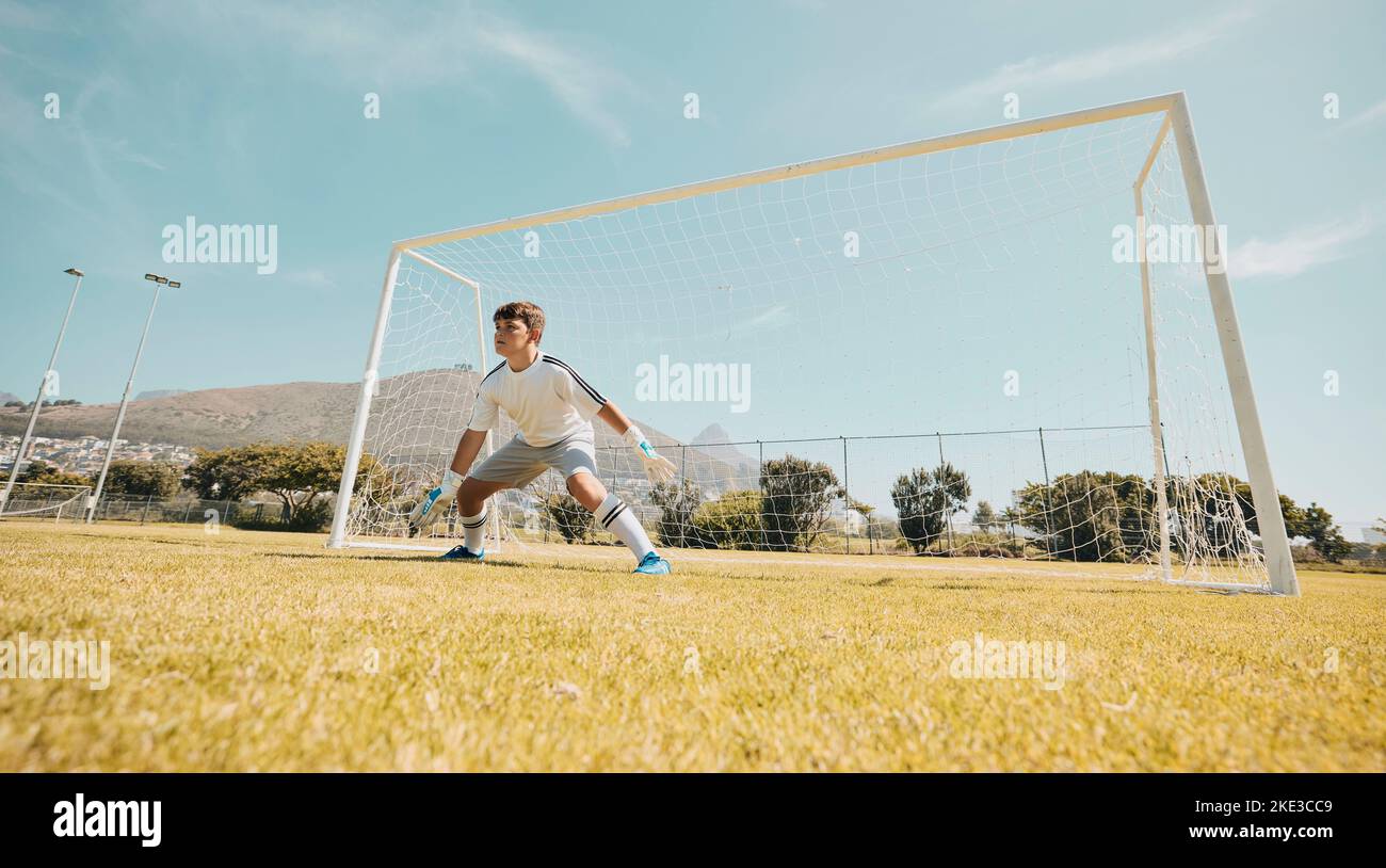 Boy, soccer field or goalkeeper in fitness game, exercise match or ...