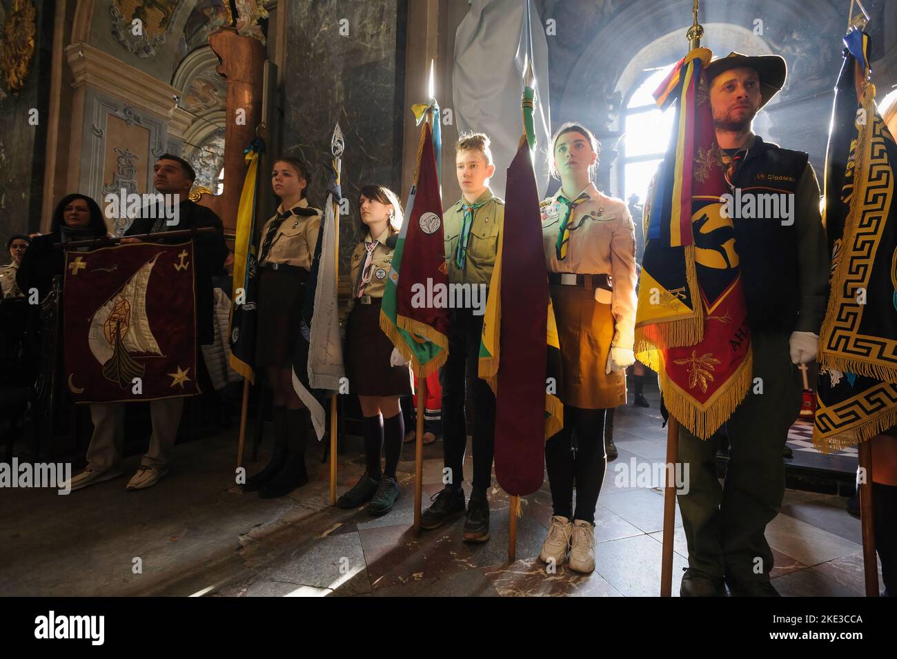 Members of the Ukrainian Plast scouting organization hold flags during ...
