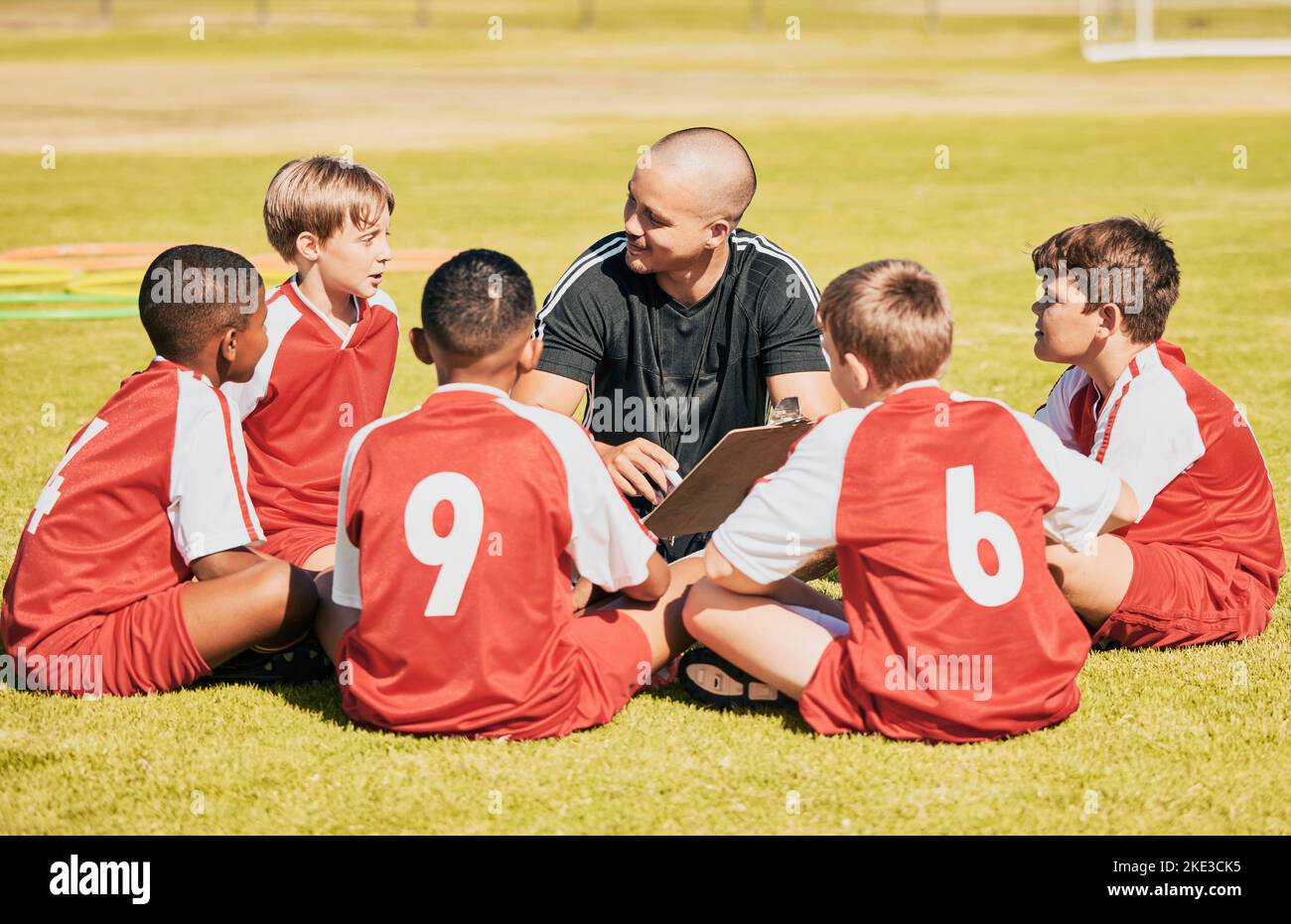 kids, soccer and team coach planning training with clipboard on soccer ...