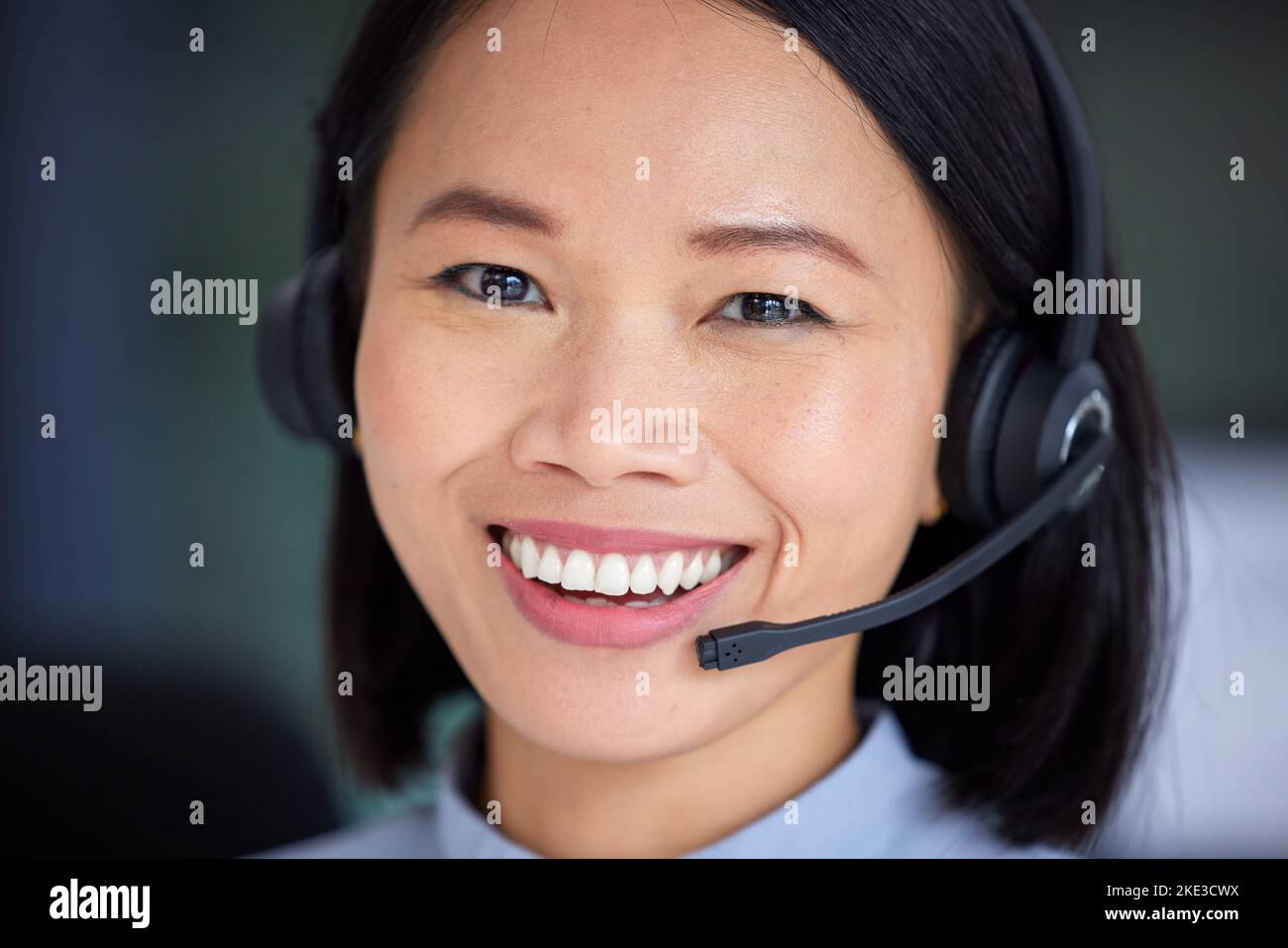 Face, telemarketing and customer support working in a call center with happy smile. Asian ...