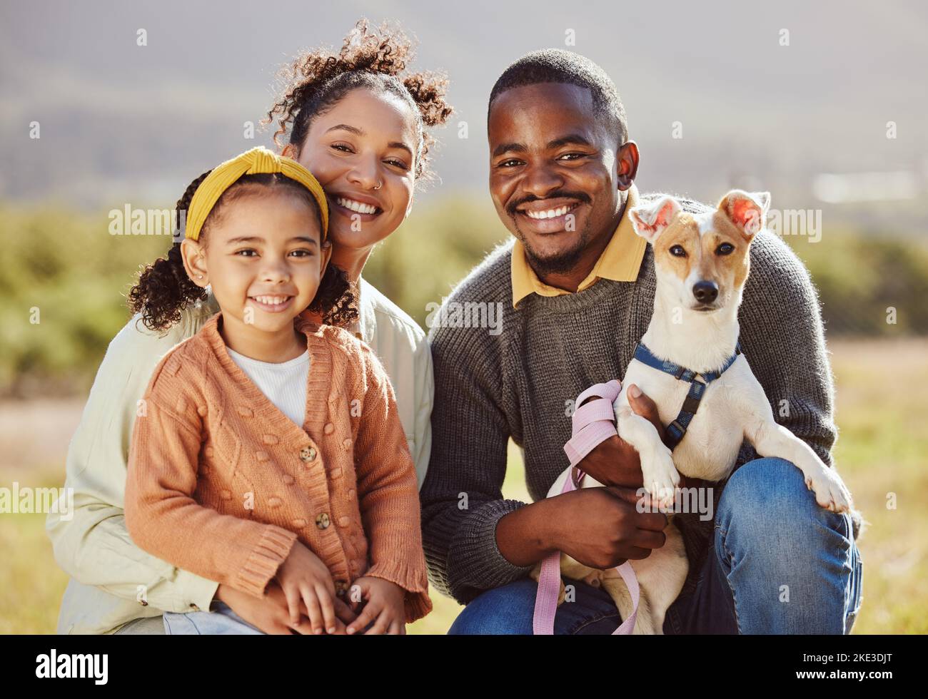 Happy family, dog and portrait and a park, relax and smile while ...