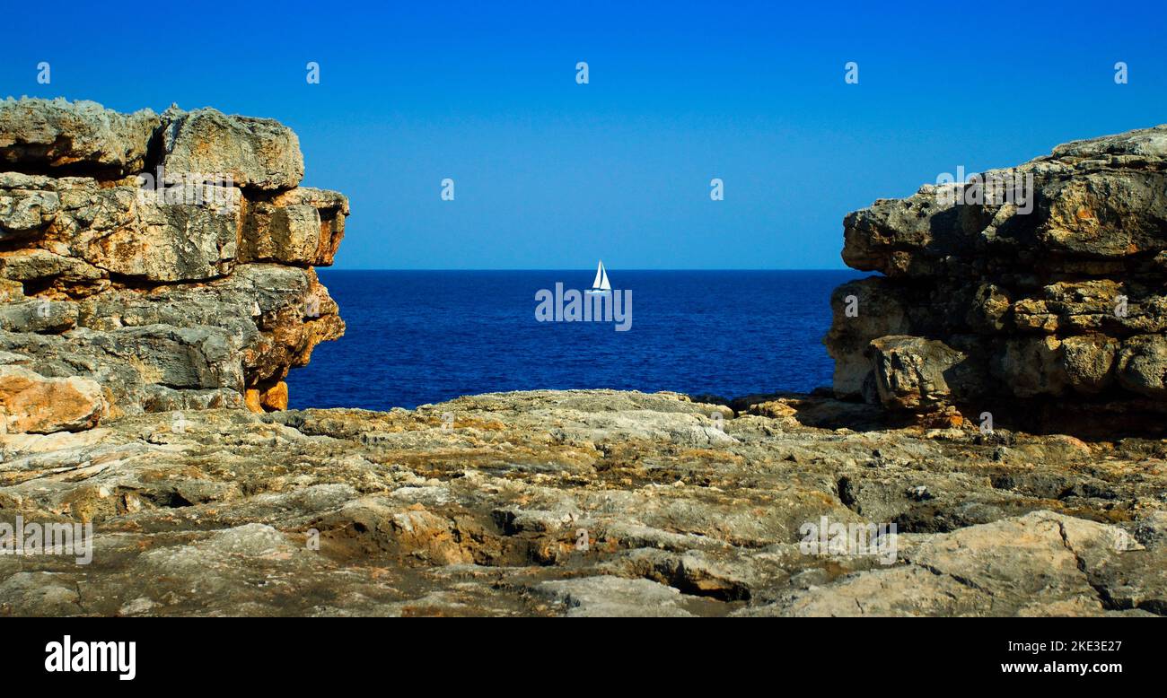 A view of the Mediterranean sea with a sailboat in the resort of Porto ...